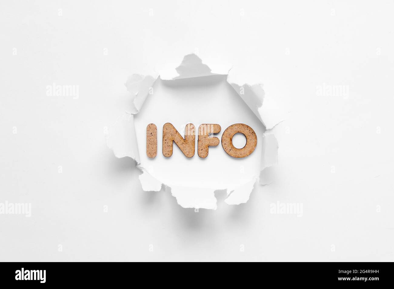 Word info in torn hole on white background. Top view Stock Photo - Alamy