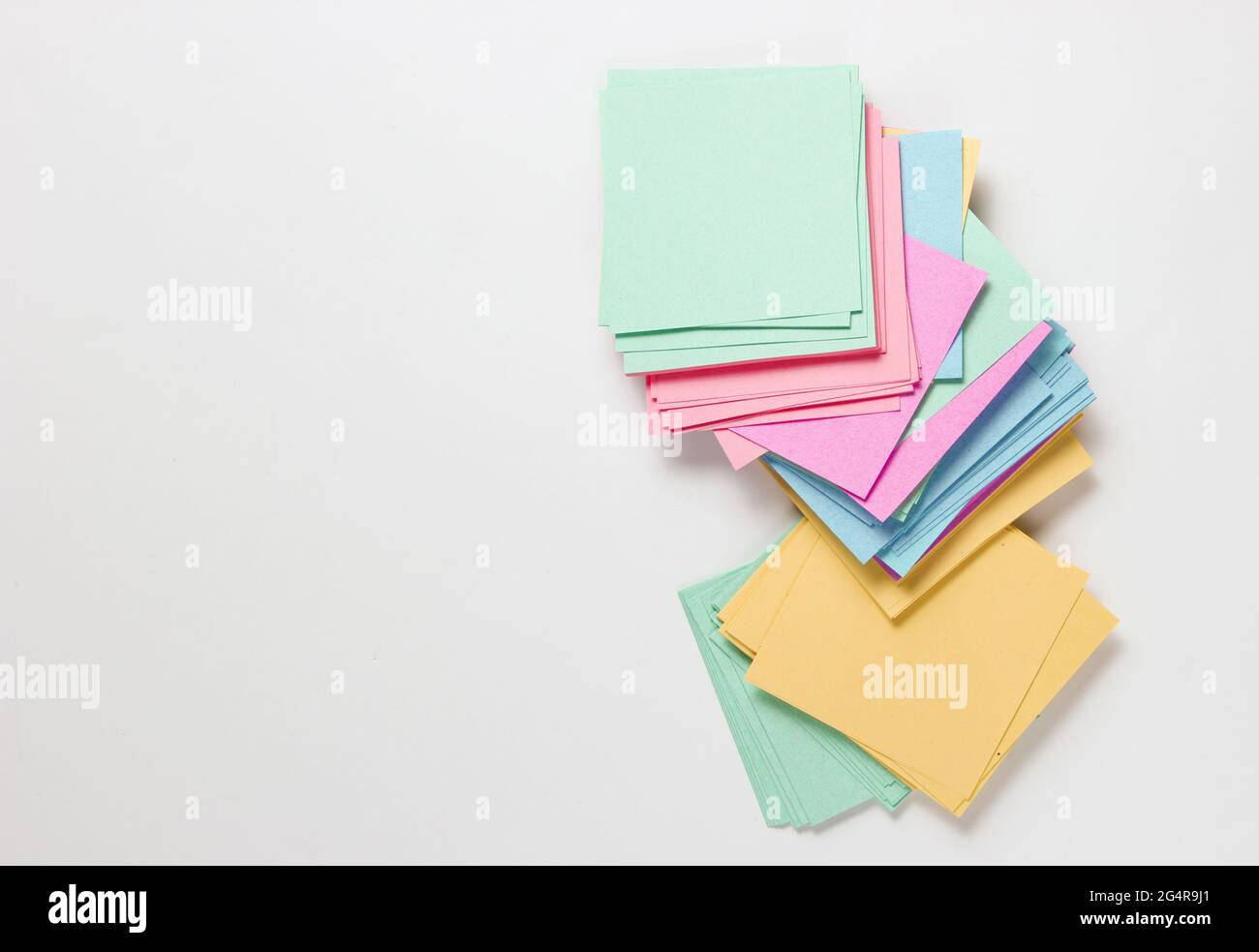 Many colored memo sheets of paper on a white background Stock Photo - Alamy