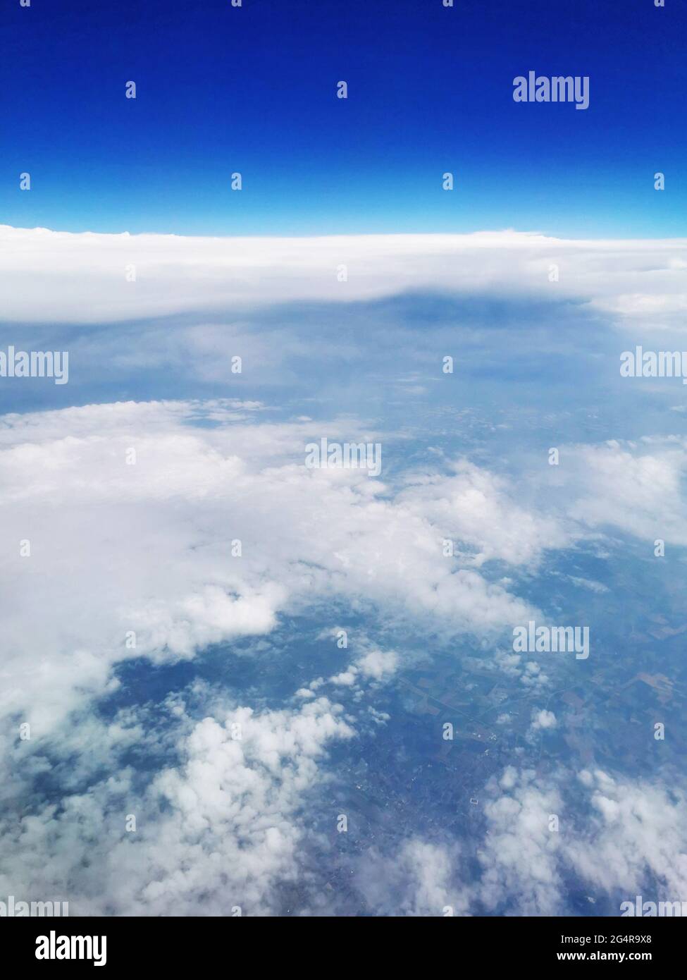Mesmerizing view from above dense fluffy clouds in the blue sky ...