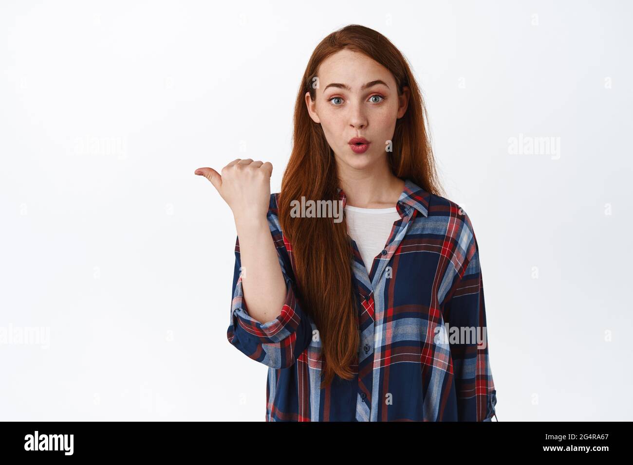 Astonished redhead woman pointing hi-res stock photography and images ...