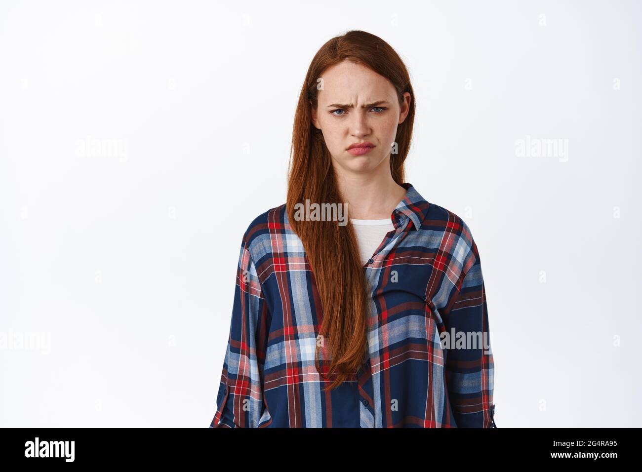 Portrait of grumpy and angry redhead woman, look hurt at unfair thing ...