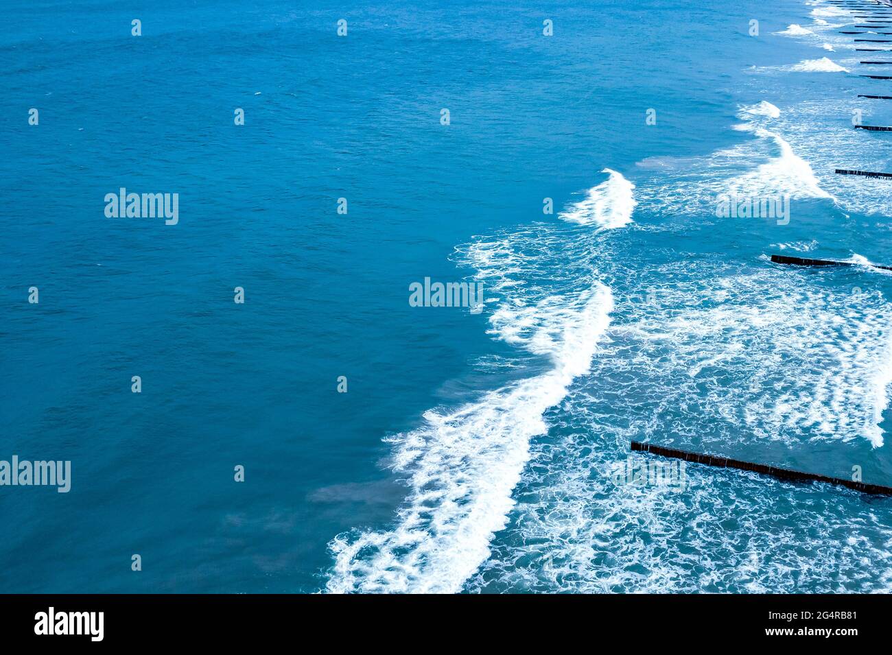 Wood Breakwater with big wave of sea, clean blue water around beach ...