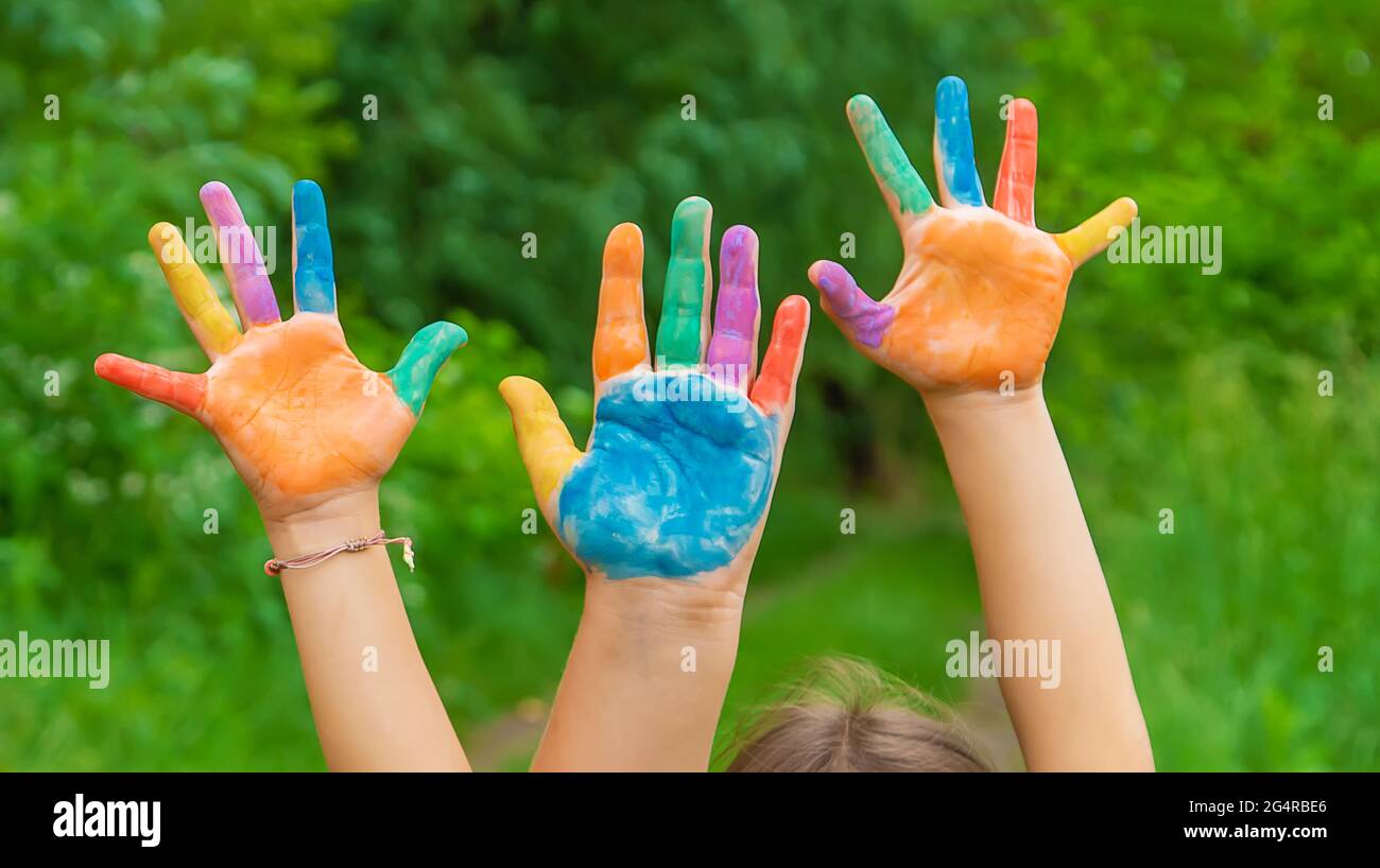 Smile on the hands of a child drawing. Selective focus. Kid Stock Photo ...