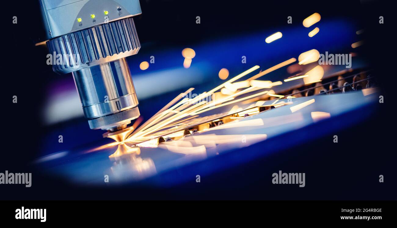 CNC Laser engraving cutting of heavy metal with light spark. Concept ...