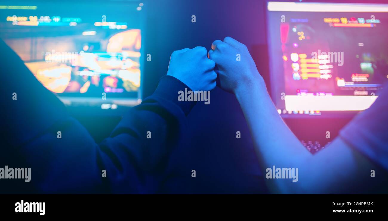 Gamers support team fists hands online game in neon color blur ...