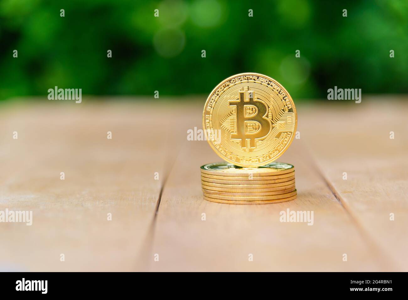 Closeup to Golden Bitcoin cryptocurrency on the wood plate Stock Photo ...