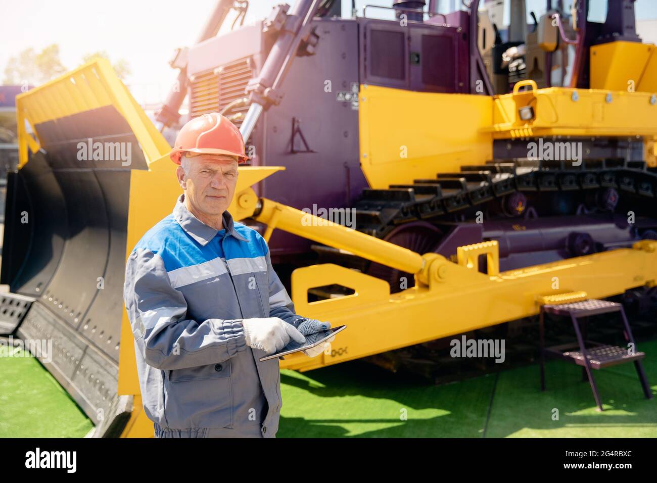 Machinery tractor mechanic checks hydraulic hose system equipment on ...