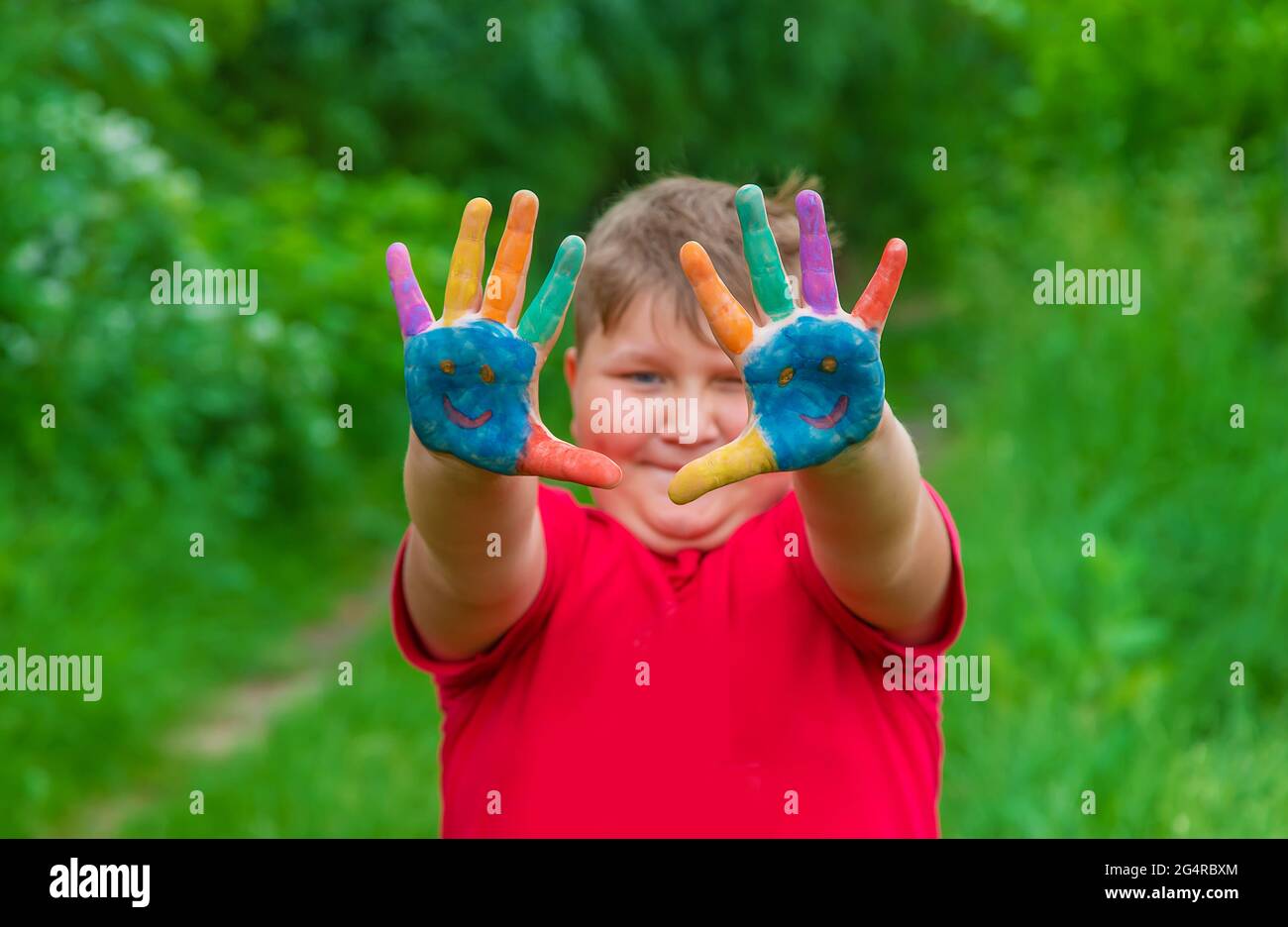 Smile on the hands of a child drawing. Selective focus. Kid Stock Photo ...