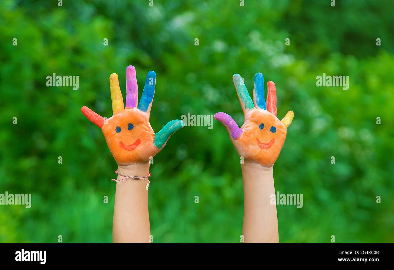 Smile on the hands of a child drawing. Selective focus. Kid Stock Photo ...