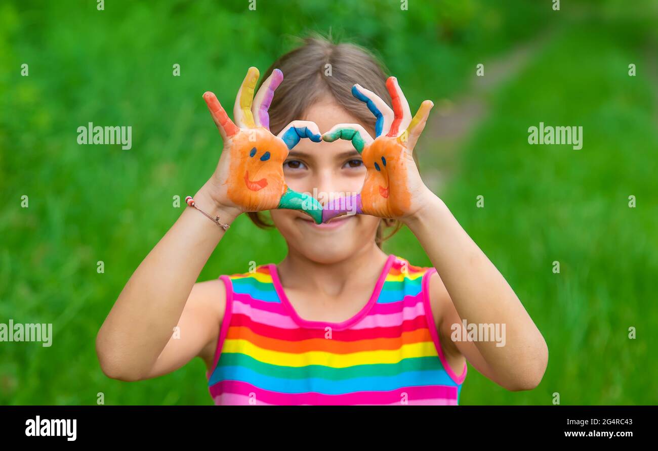 Smile on the hands of a child drawing. Selective focus. Kid Stock Photo ...