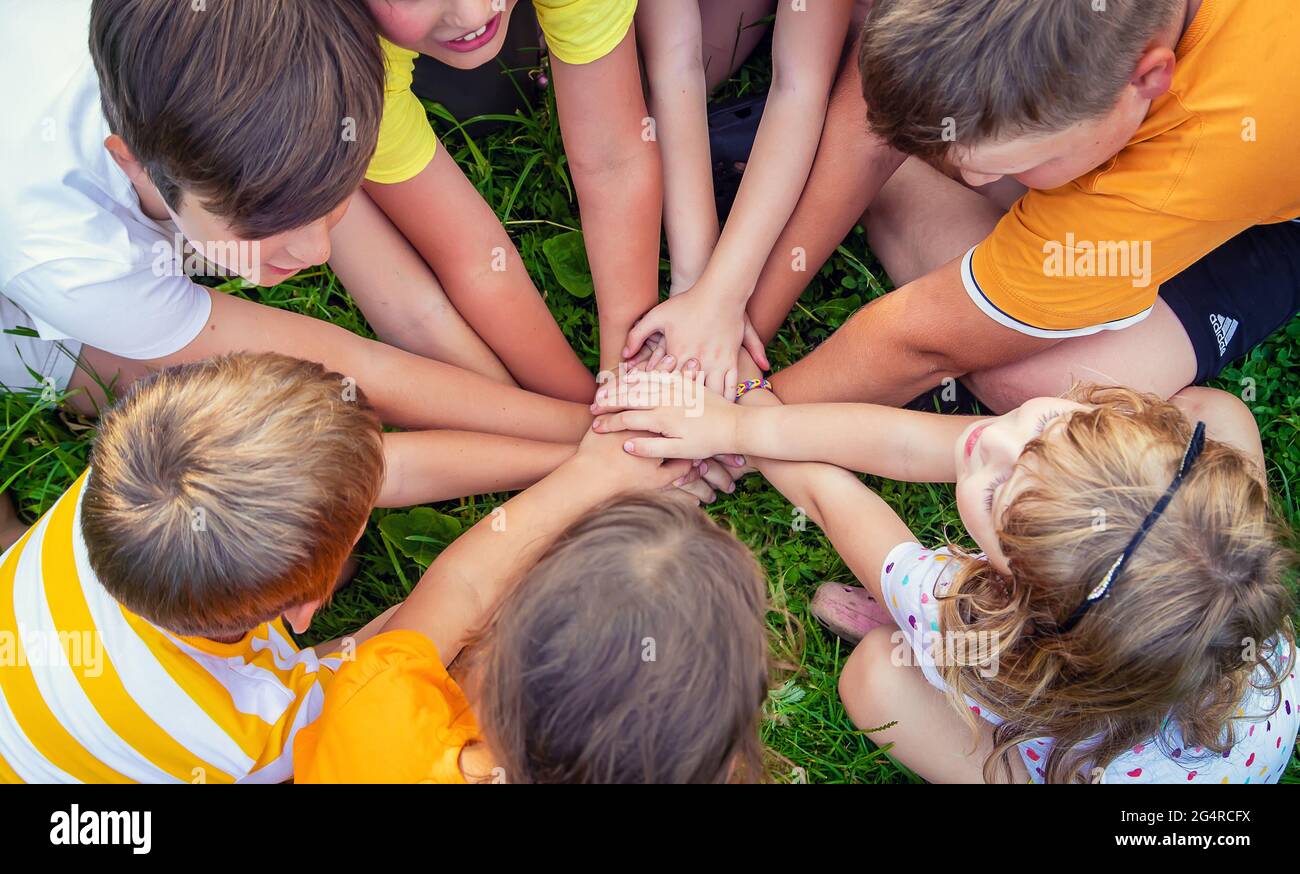 Children are playing with their hands clasped together. Selective focus ...