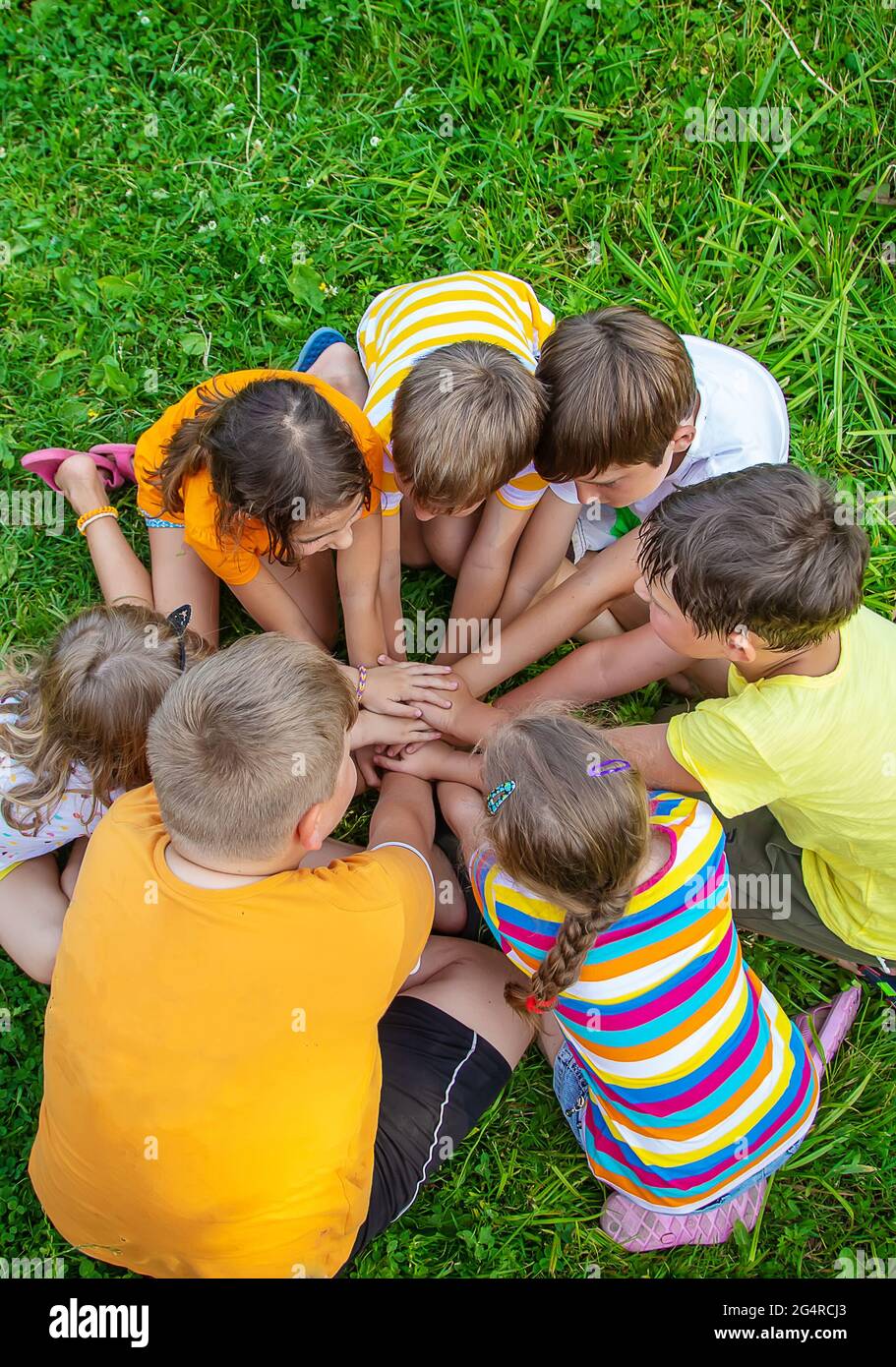Children are playing with their hands clasped together. Selective focus ...