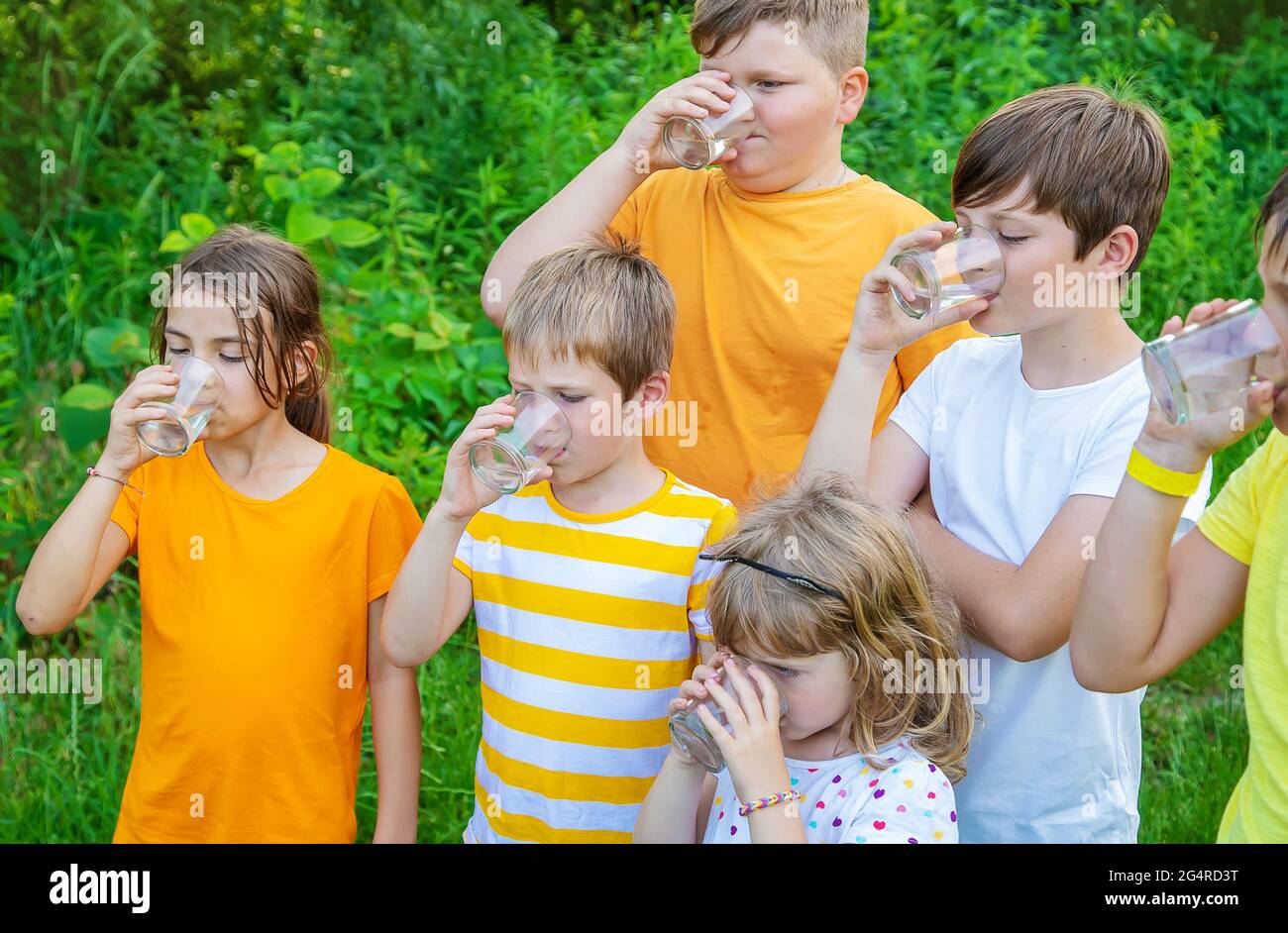 Children drink water outside together. Selective focus. Kids Stock ...