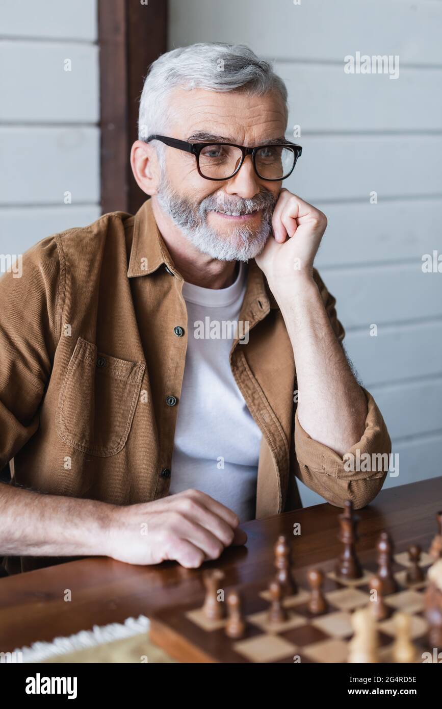 Man sitting on chessboard hi-res stock photography and images - Alamy