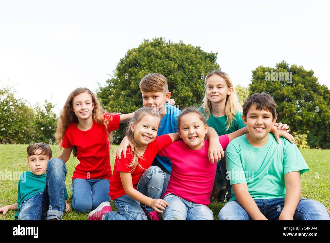 Group of happy children showing unity Stock Photo - Alamy