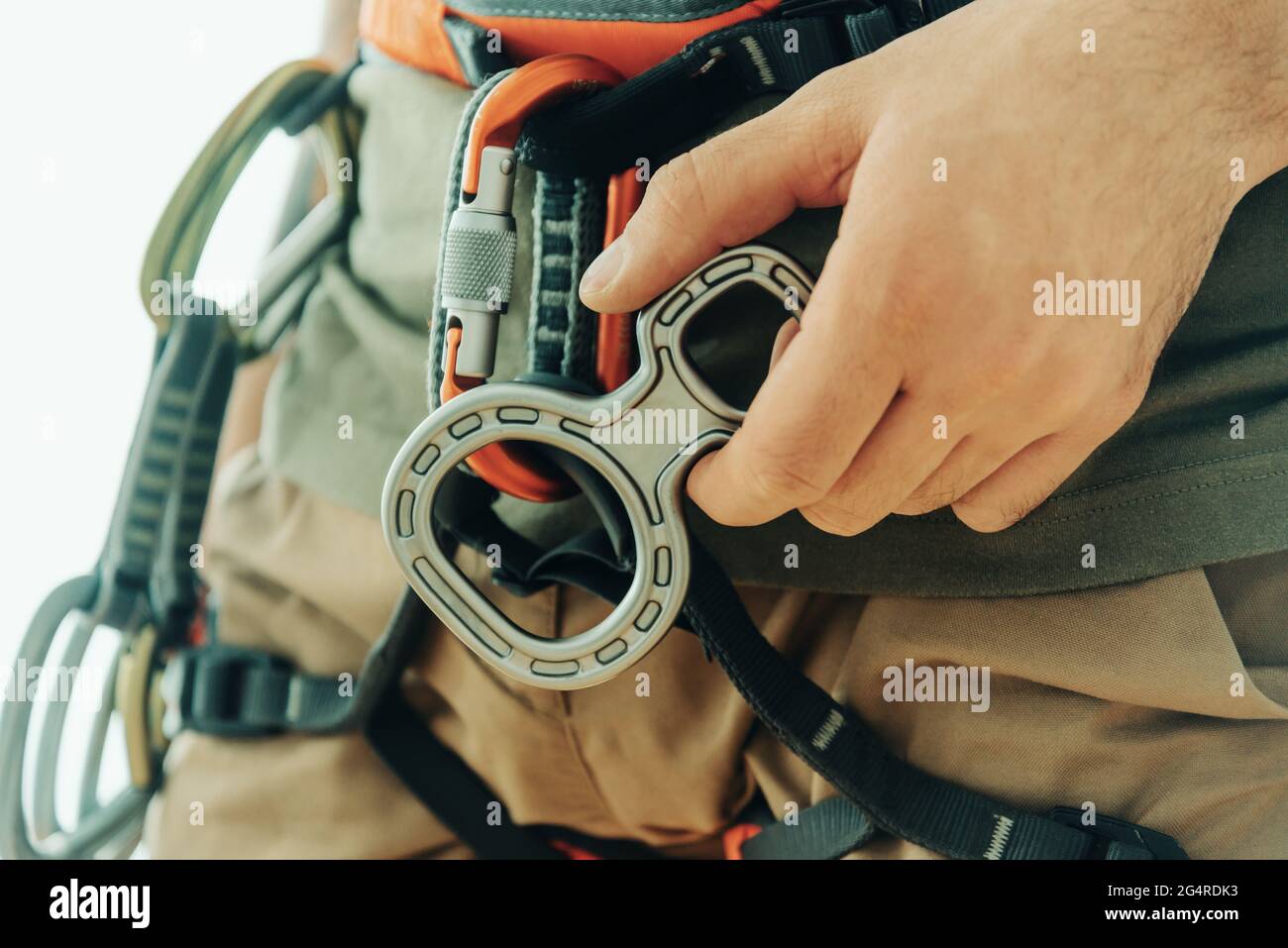 The climber shows a special 'Eight' device for belaying Stock Photo - Alamy