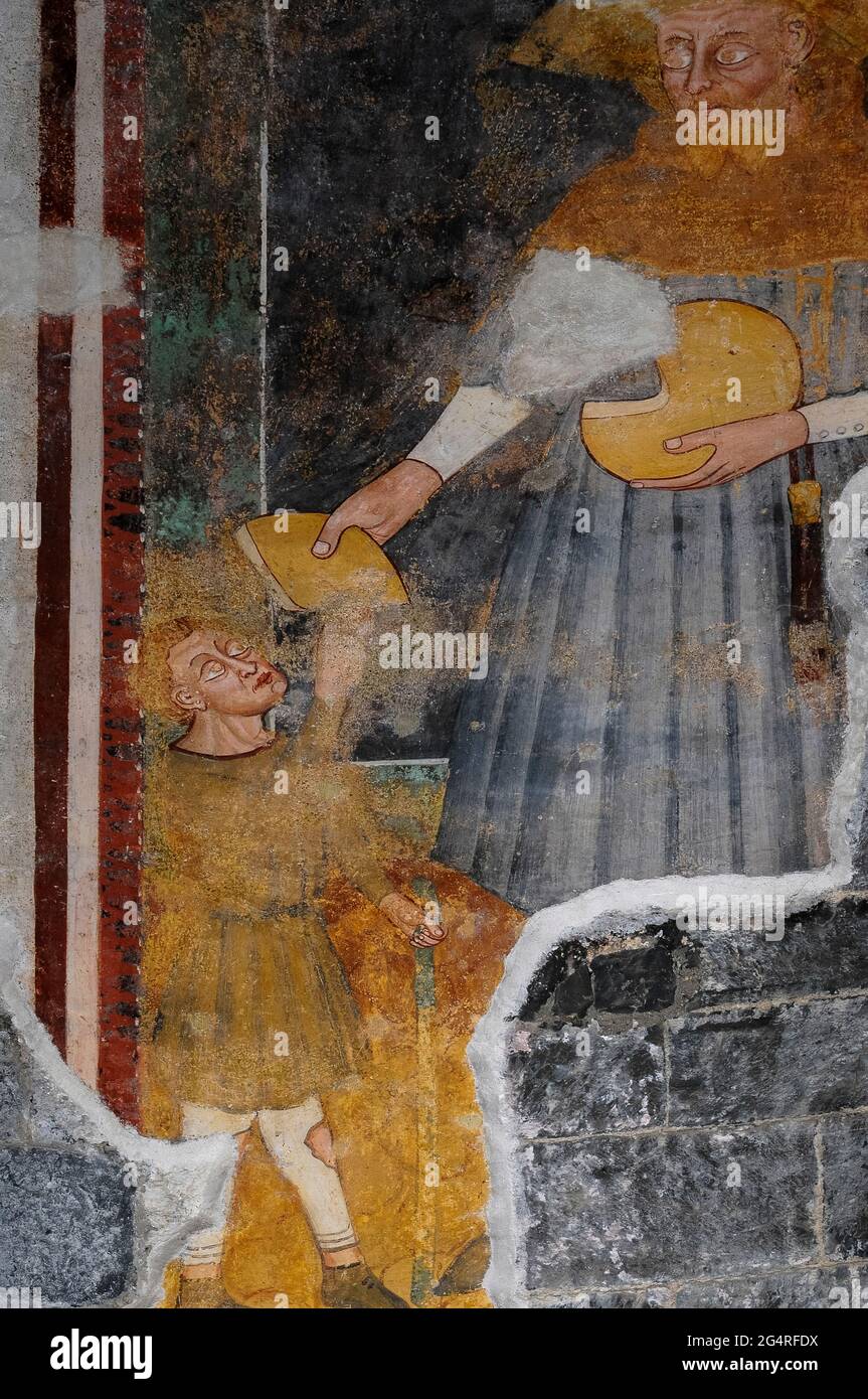 Patron saint of cheese-makers and sellers, San Lucio, gives cheese to a ...