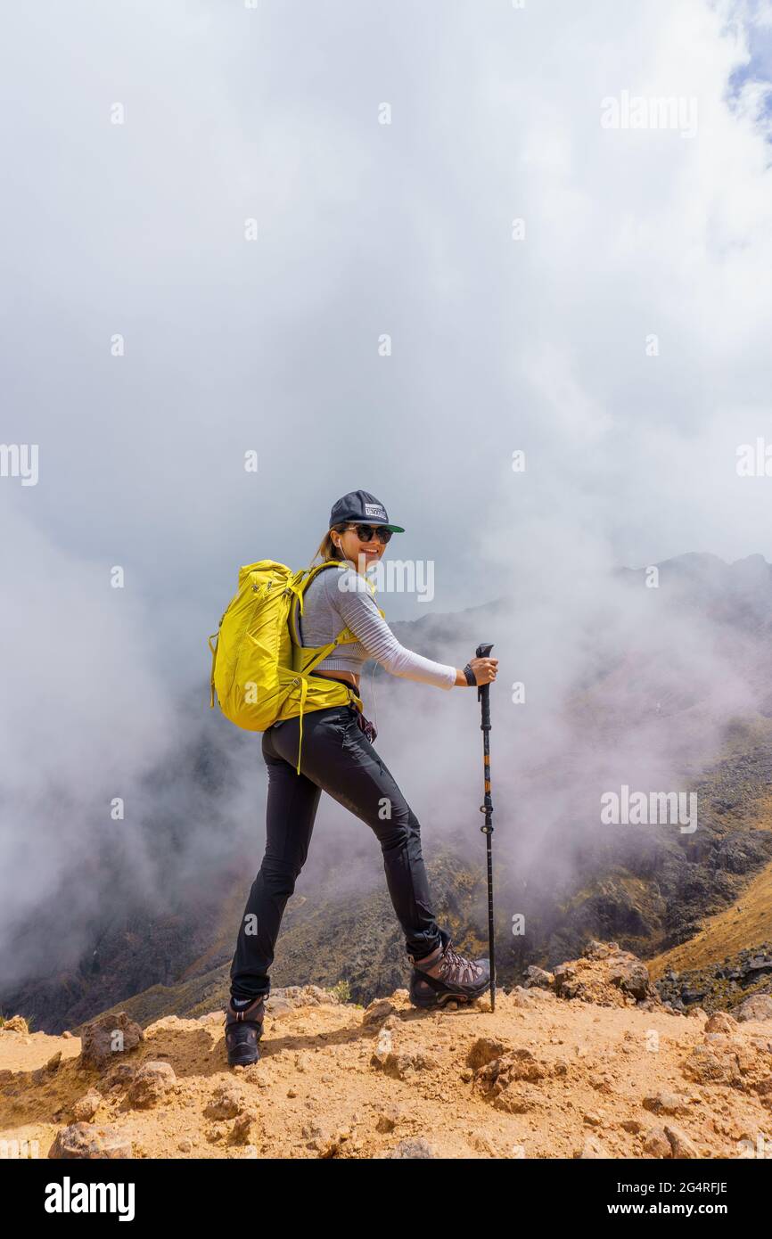 Vertical shot of a happy Mexican hiker smiling on the peak of the ...