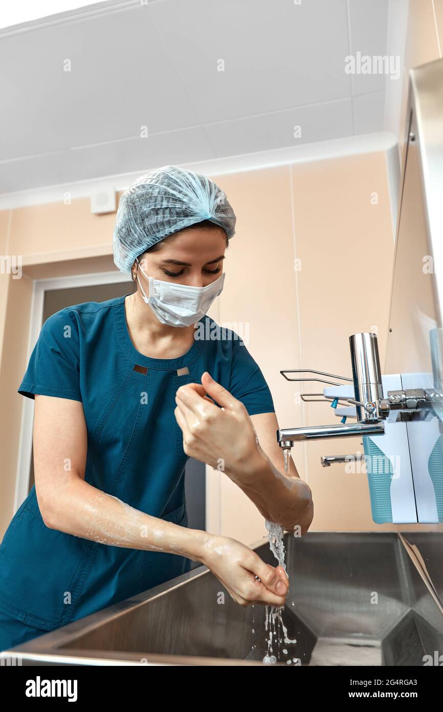 Woman doctor, washing her hands close-up, in the preoperative unit ...