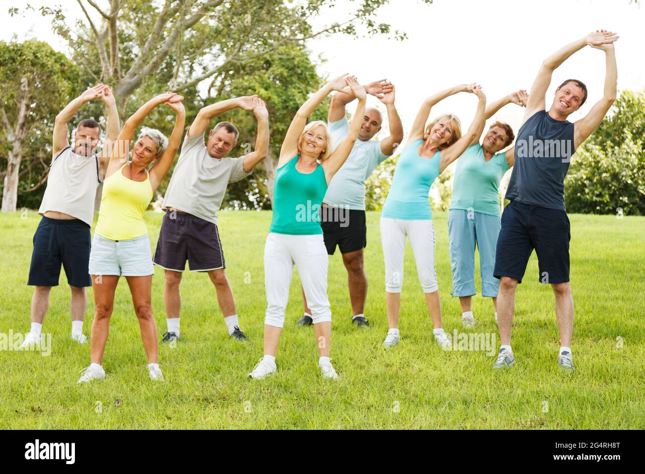Group of people doing flexibility exercises Stock Photo - Alamy