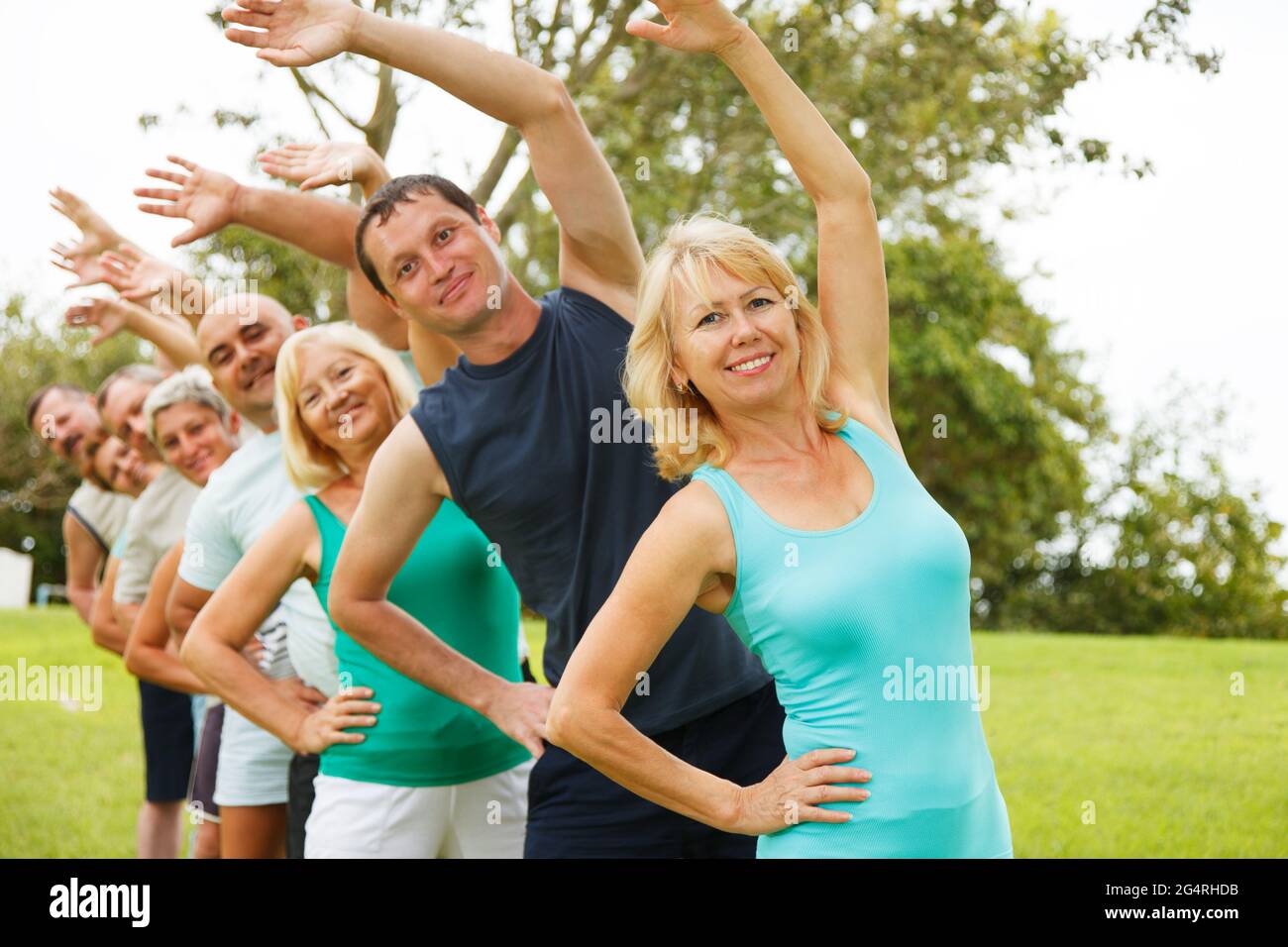 Group of People doing flexibility exercises.Focus on foreground Stock ...