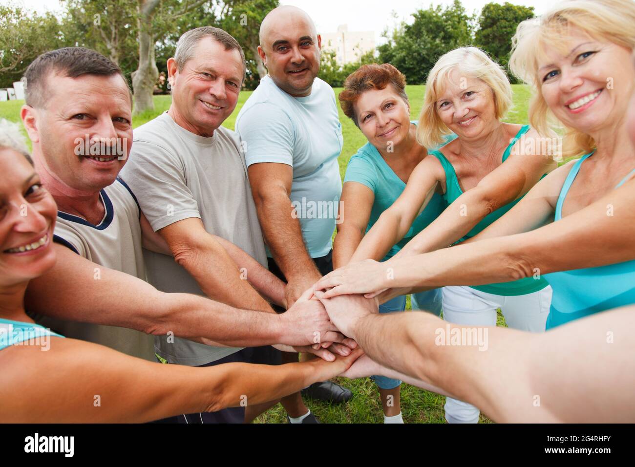 Crowd standing holding hands raised celebration hi-res stock ...