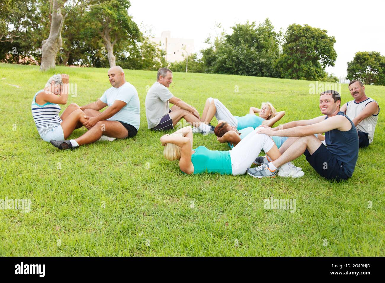 Group of People doing flexibility exercises Stock Photo - Alamy