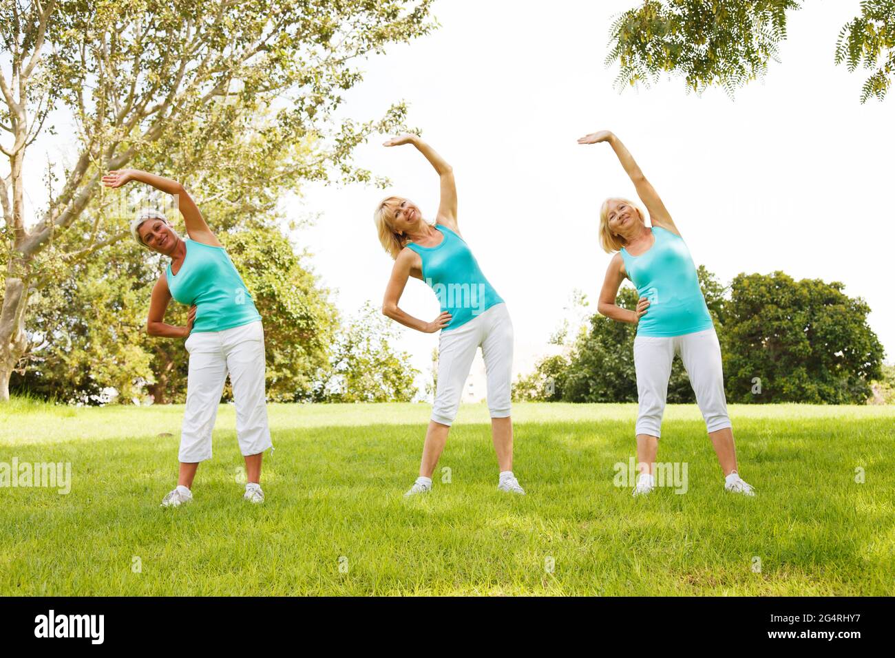 Group of People doing flexibility exercises Stock Photo - Alamy