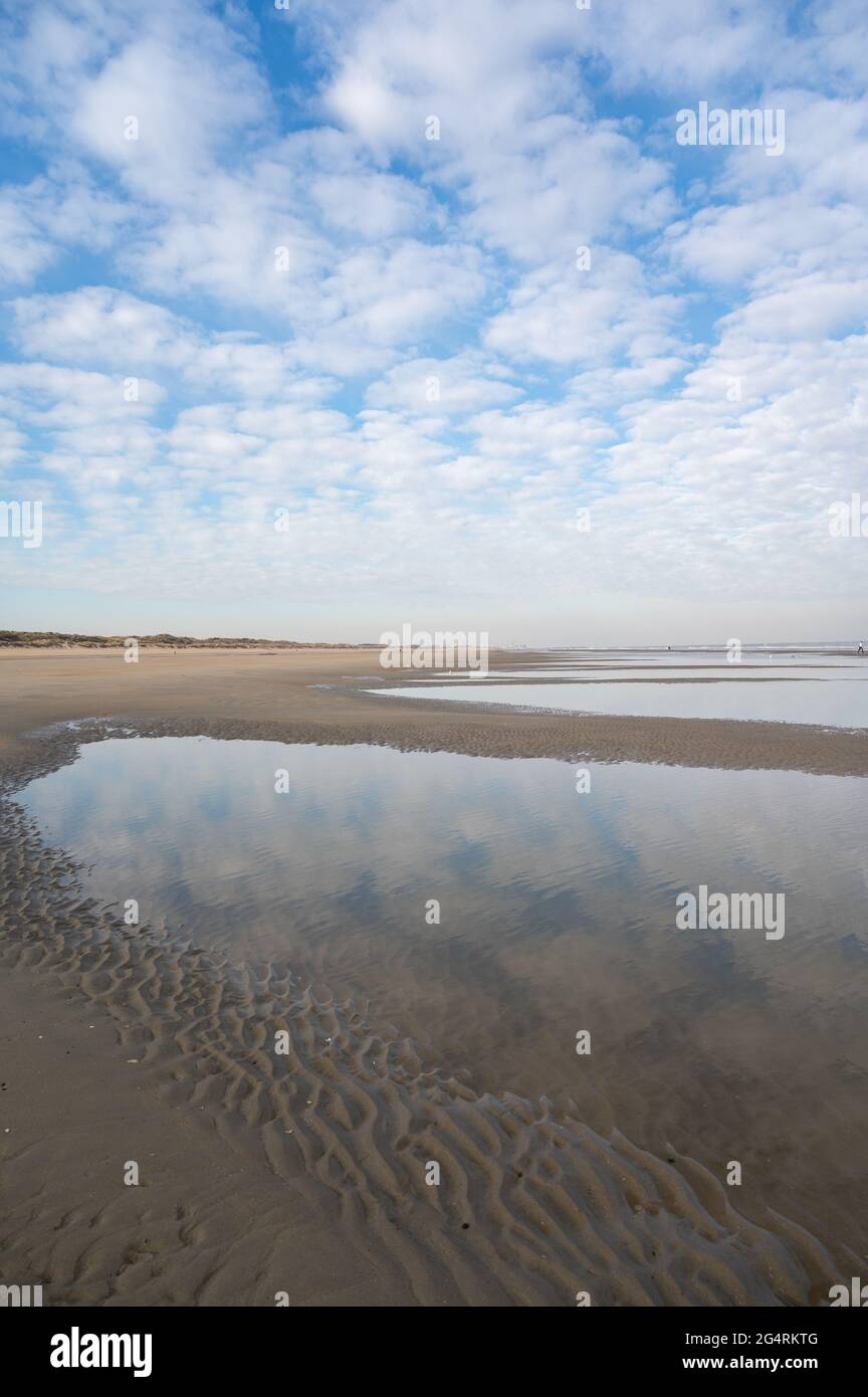 Low ride period on yellow sandy beach in small Belgian town De Haan or ...