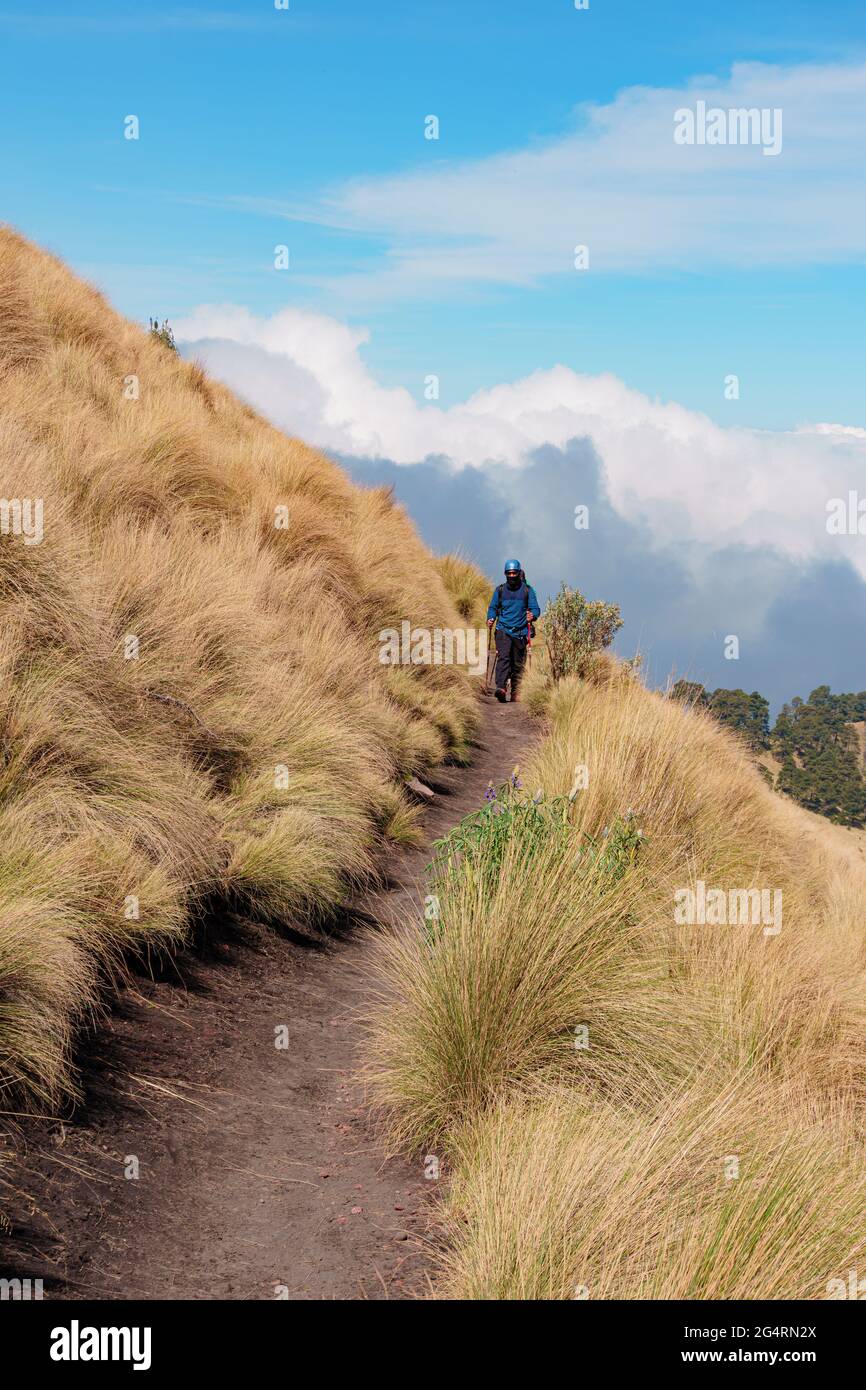 Vertical shot of a hiker on a trail climbing the Iztaccihuatl volcano ...