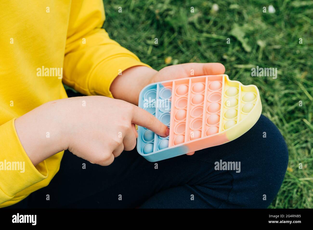 Young Girl Holding Pop It Fidget Toy in hands. Teen Playing, Push ...