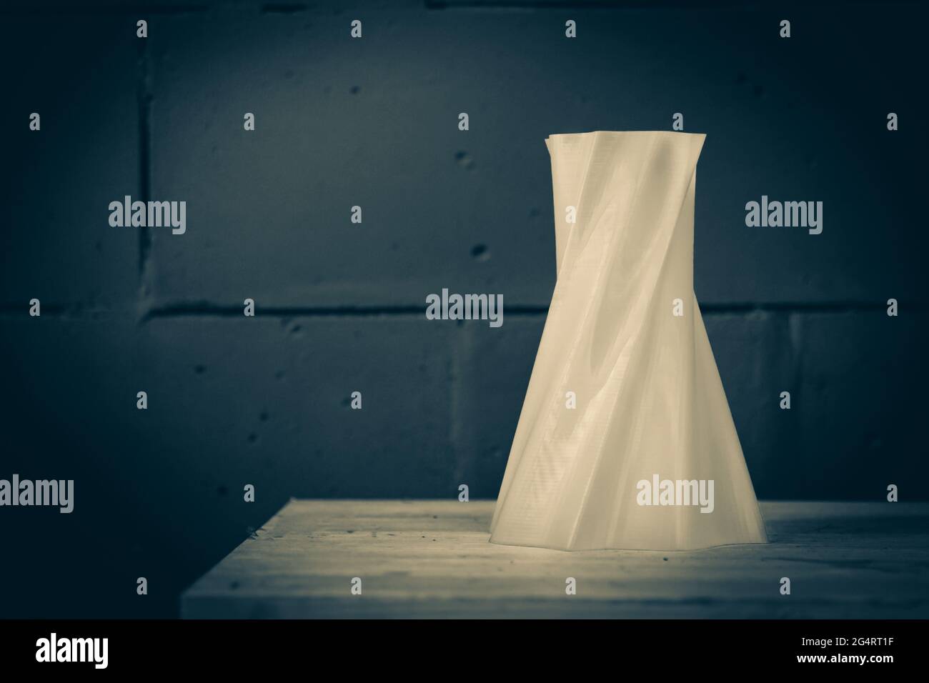 Bright red object vase printed by 3d printer on blue brick wall Stock ...