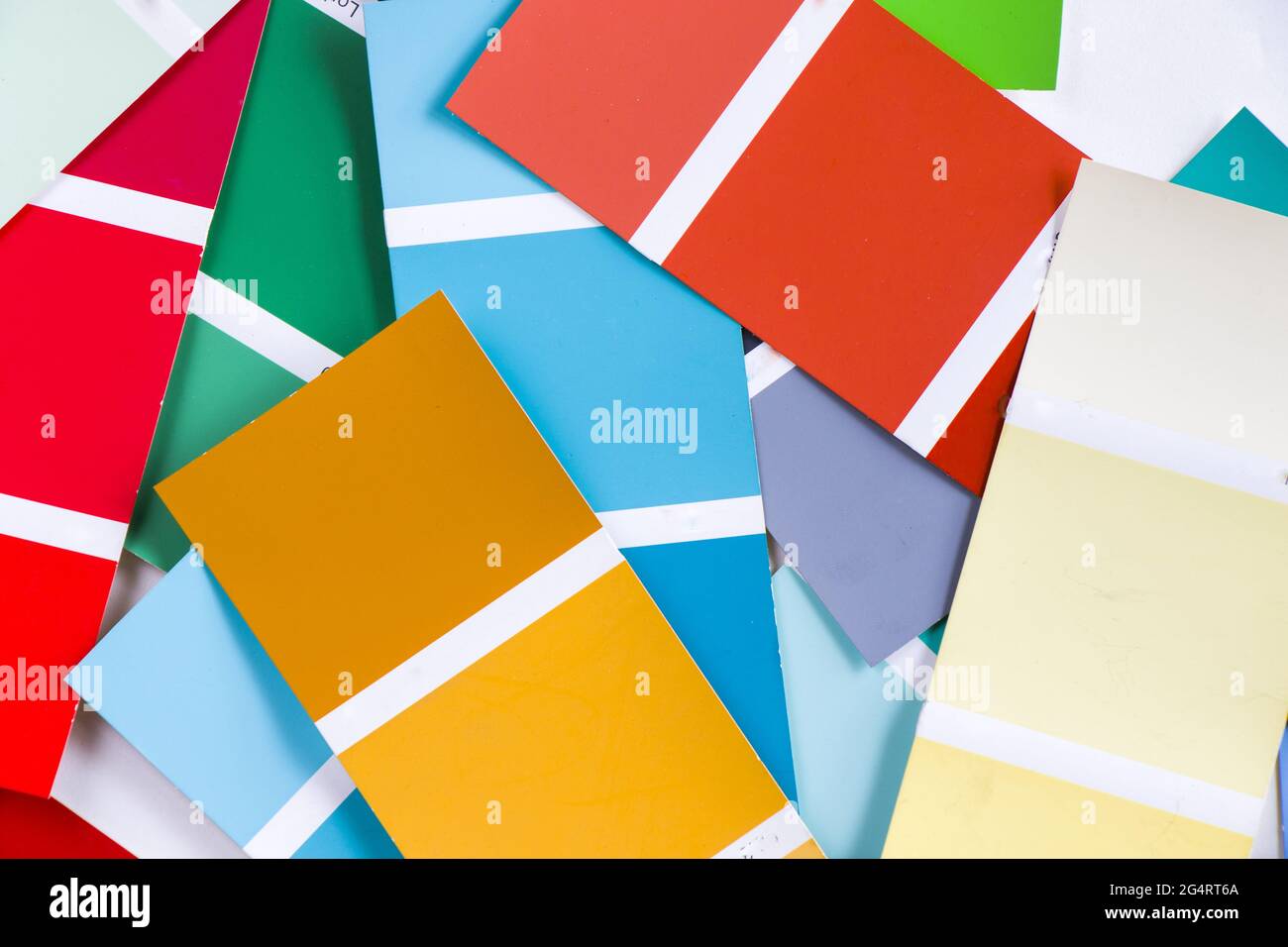 Top view of a pile of messy, scattered color charts of various gradient ...