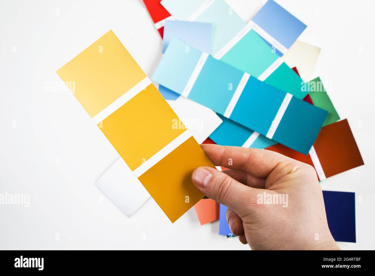Hand holding a gradient yellow color chart with more varieties of color ...