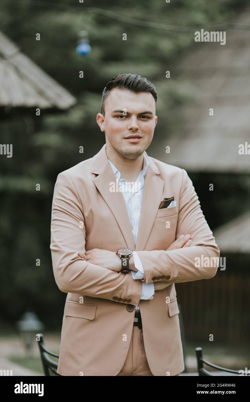 Vertical shot of a young handsome Caucasian male wearing a nice elegant ...