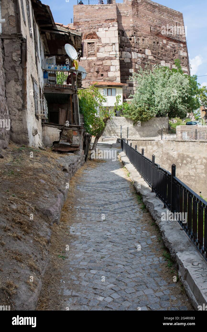 Narrow walking path around Ankara Castle and view of the castle tower ...