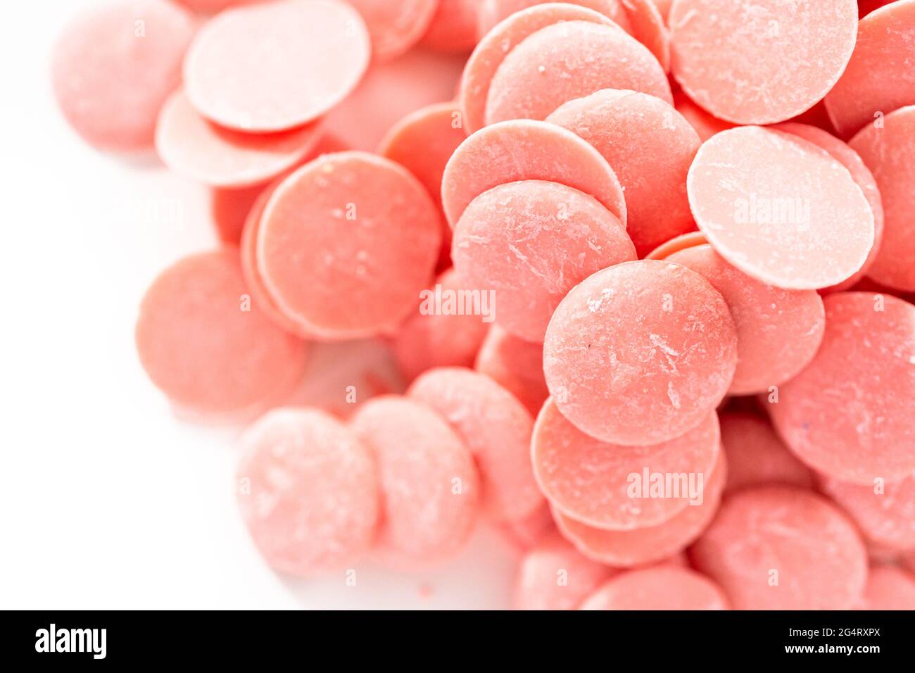 Pink round chocolate chips for melting chocolate shapes on a white ...