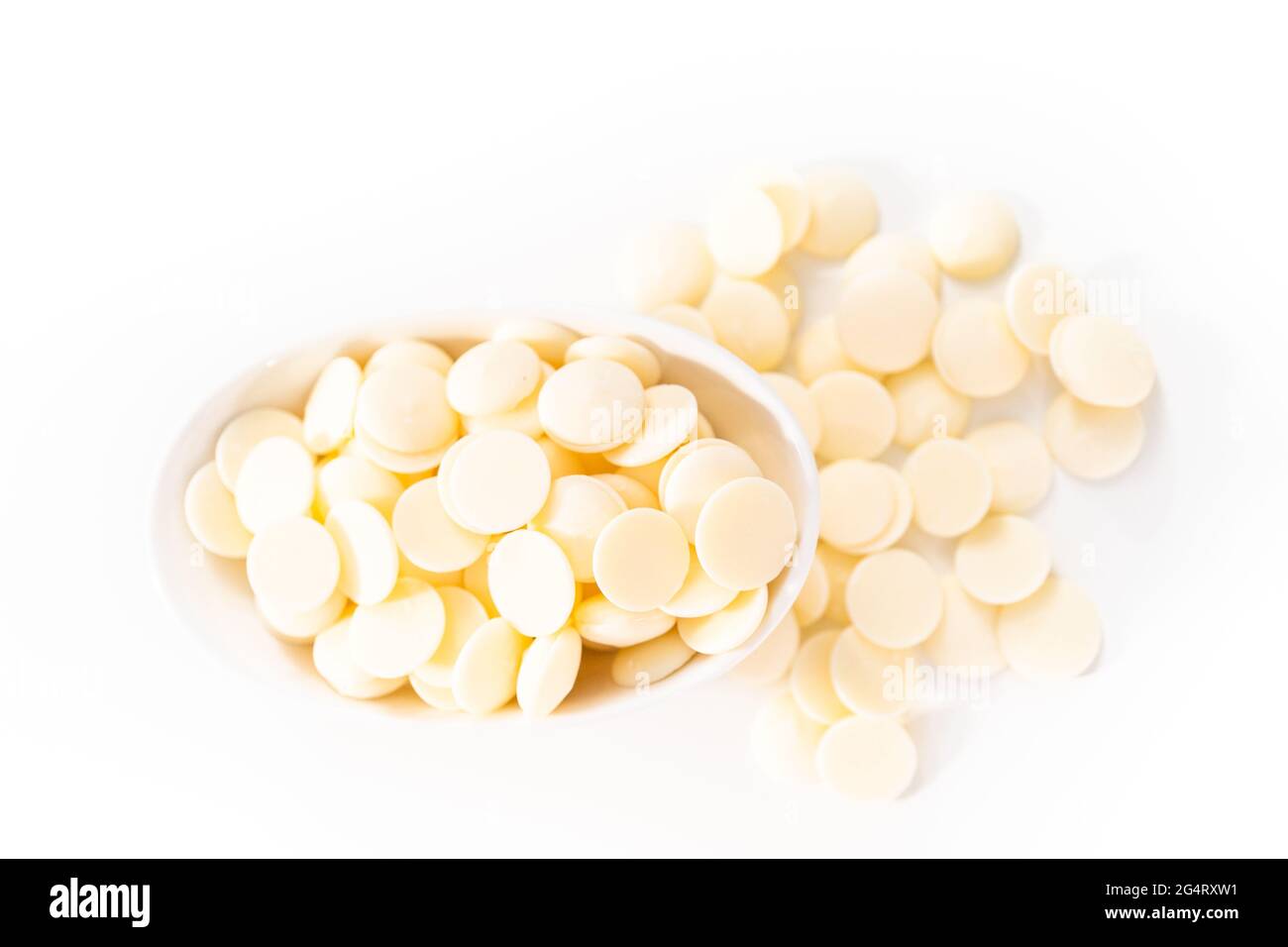 White round chocolate chips for melting chocolate shapes on a white ...