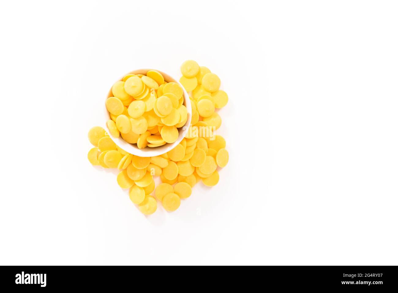 Flat lay. Yellow round chocolate chips for melting chocolate shapes ...