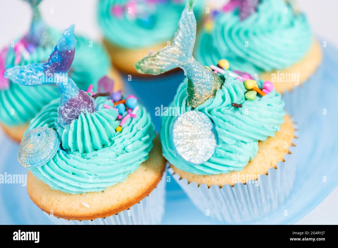 Gourmet mermaid cupcakes topped with blue buttercream frosting and ...