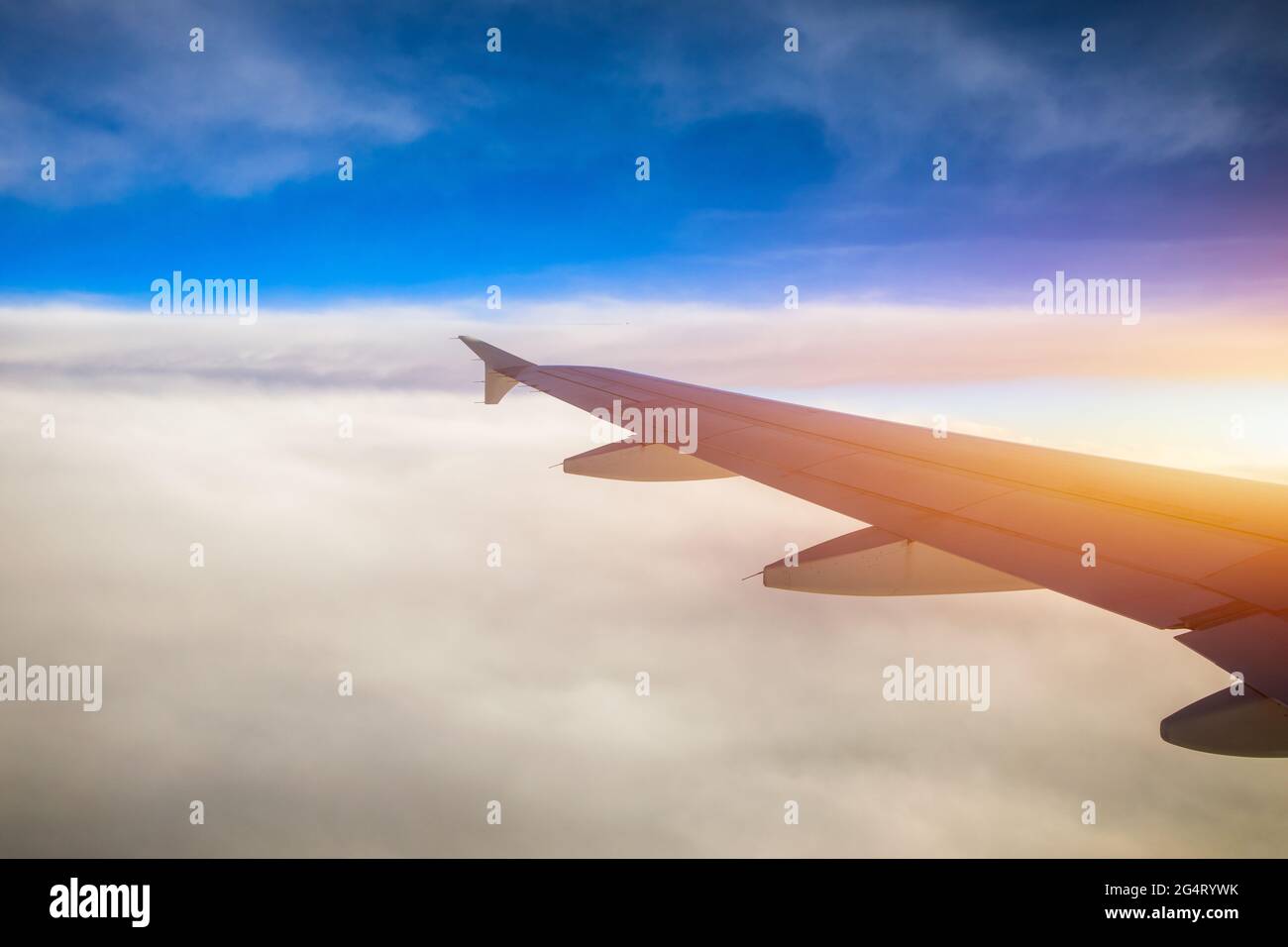 Flying and traveling, view from airplane window on the wing on sunset ...