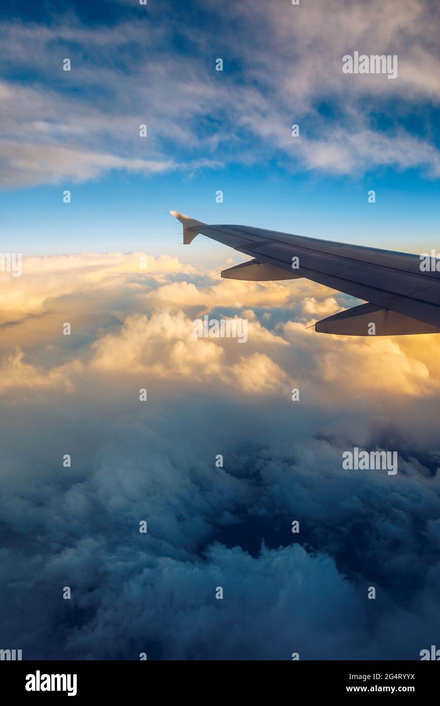 Flying and traveling, view from airplane window on the wing on sunset ...