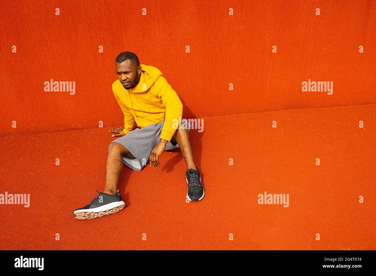 African-American sportsman athlete having break rest after doing sport ...