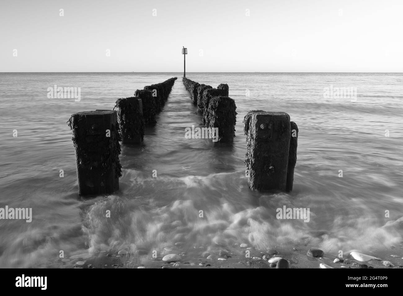 Black and white photograph of groynes at the north beach in Bridlington ...