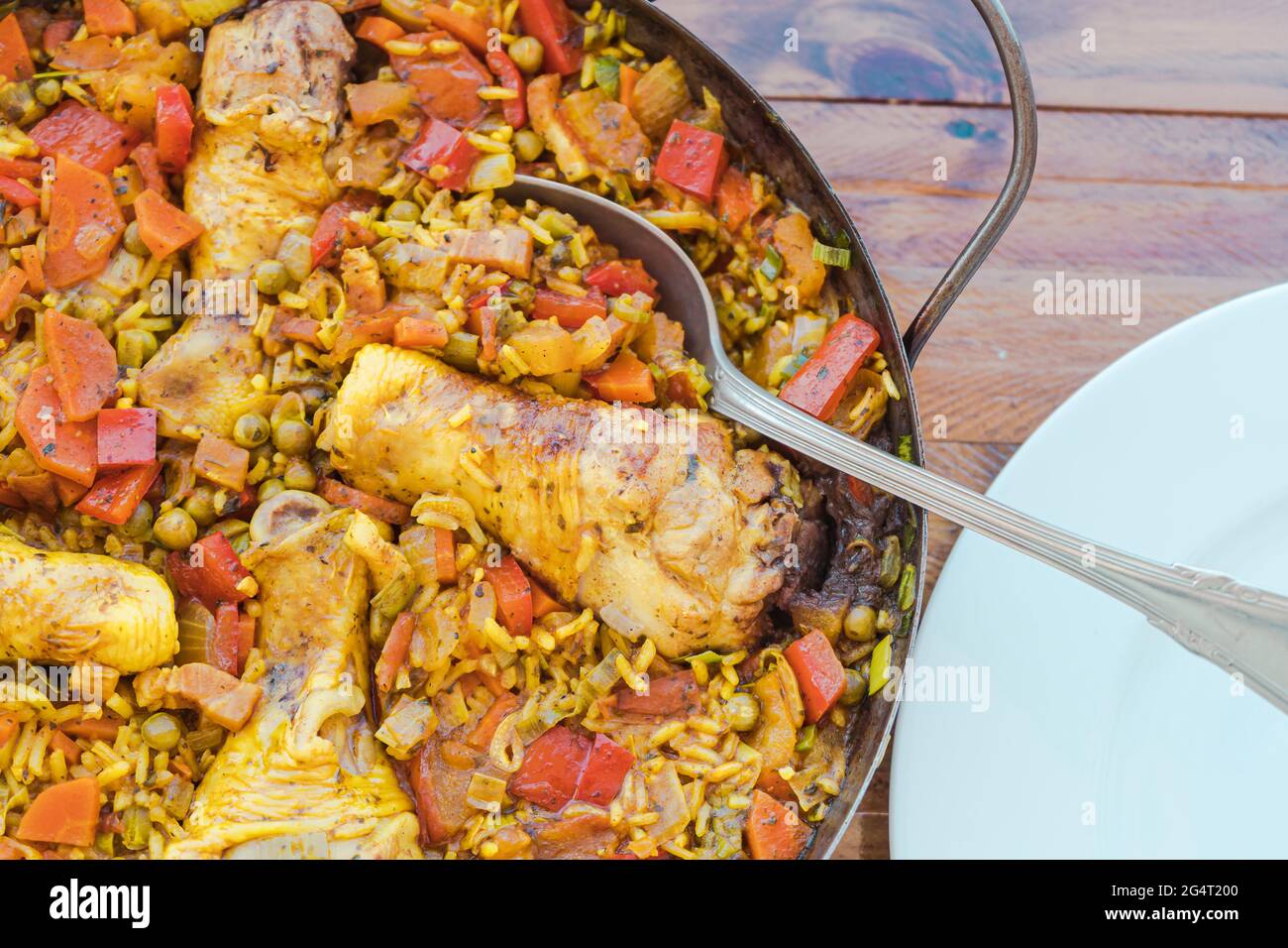 Detail of a typical paella pan with rice with chicken and saffron or ...