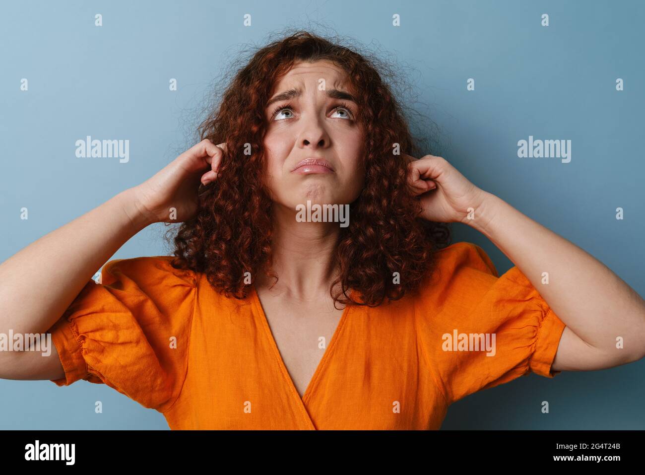 Woman plugging ears hi-res stock photography and images - Alamy