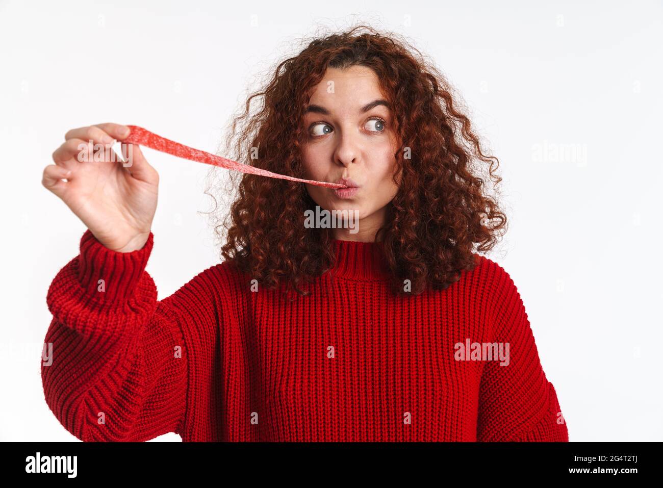 Shocked ginger young woman making fun with gummy isolated over white ...