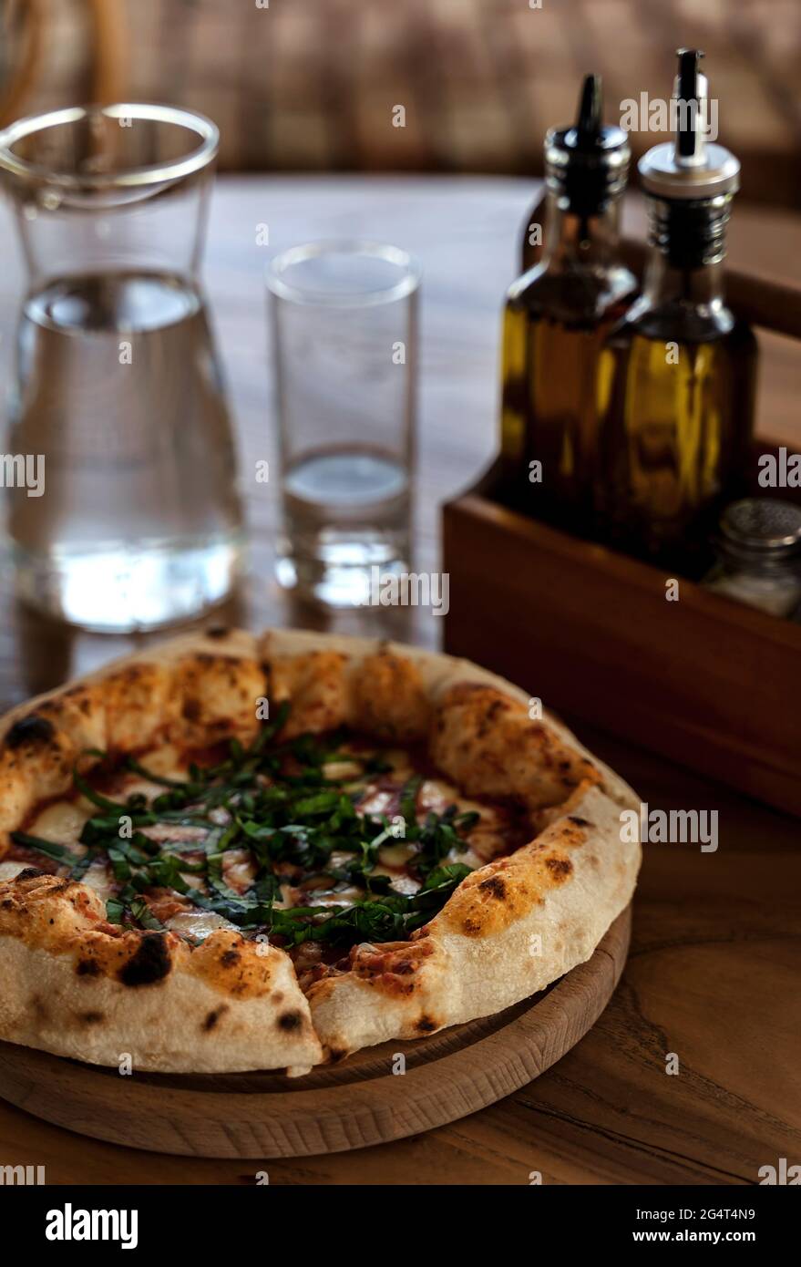 Pizza on wooden table in vintage style. Italian restaurant background ...