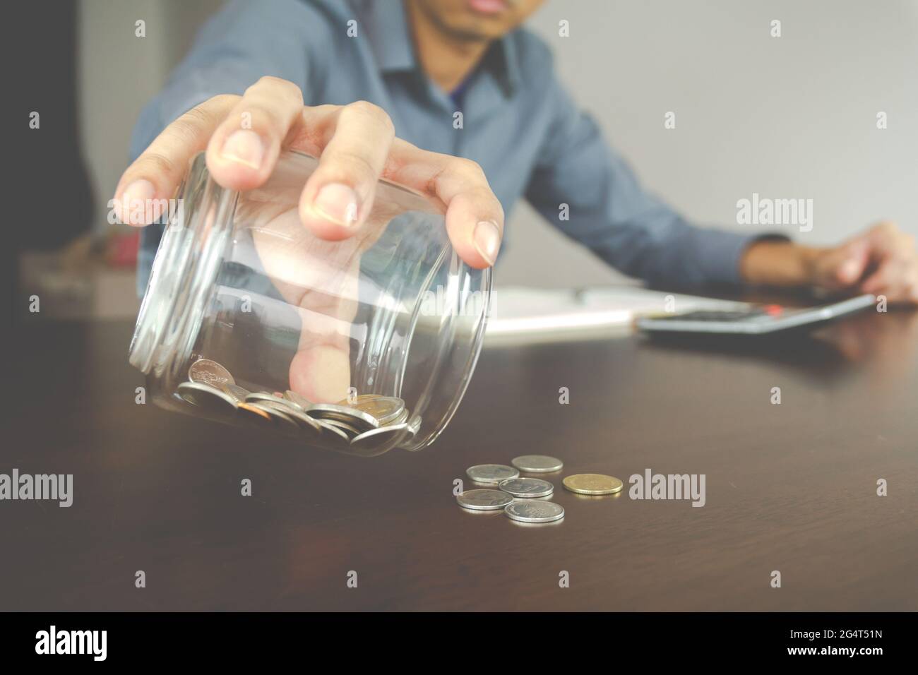 Money accounting concept. Businessman check coin in the bottle ...