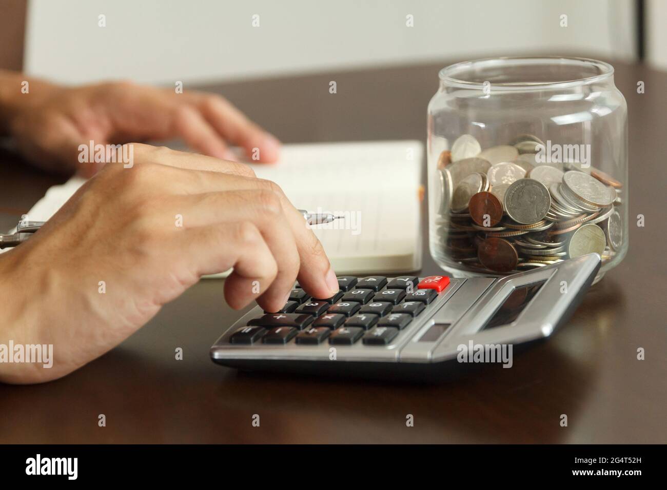 Money management concept. Hand man use calculator to calculate the ...